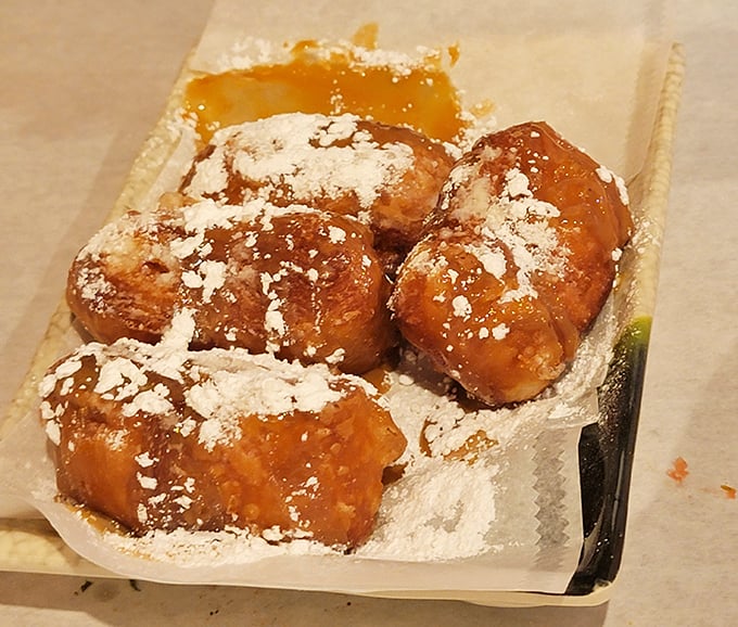 These beignets aren't just dessert; they're little powdered pillows of joy that would make any New Orleans grandmother nod in approval. Worth every speck of sugar on your shirt.