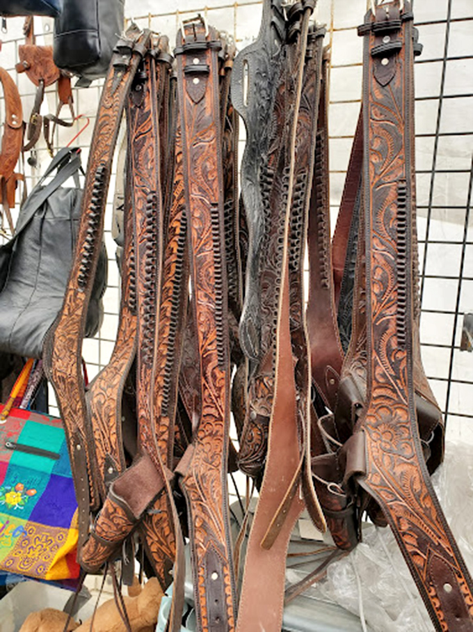 Tooled leather belts showcase Western craftsmanship at its finest—each floral pattern and intricate design a wearable piece of Southwestern art.