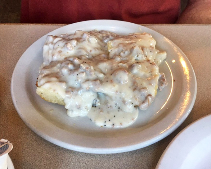 Biscuits swimming in creamy sausage gravy—the breakfast equivalent of a warm hug that says, "Go back to bed if you want, but you'll miss this."