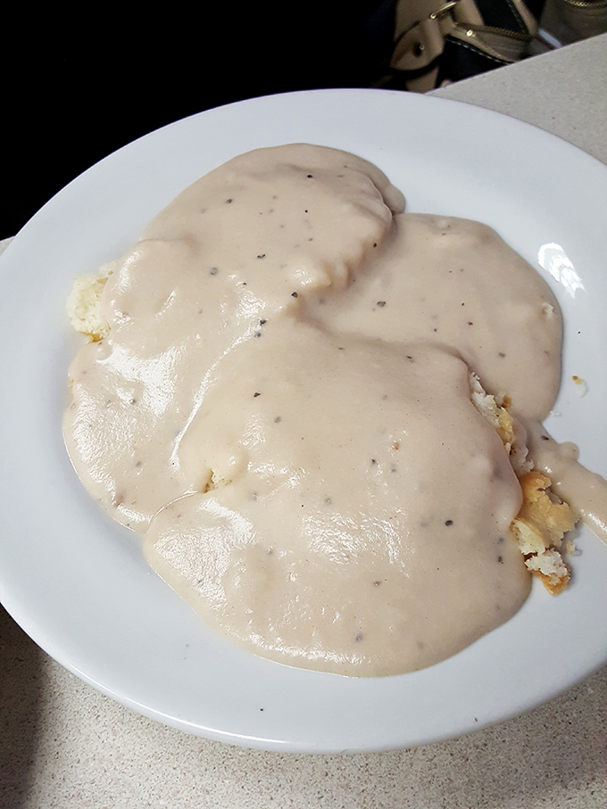 Biscuits smothered in creamy pepper gravy—the kind of breakfast that makes you want to take a nap immediately after finishing it.