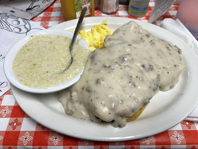Biscuits smothered in country gravy so thick you could stand a spoon in it. This isn't breakfast—it's edible Southern comfort.