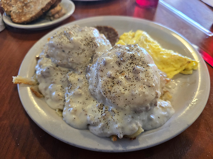 Biscuits and gravy that could make a Southern grandmother weep with joy—pillowy clouds drowning in peppery, sausage-studded heaven.