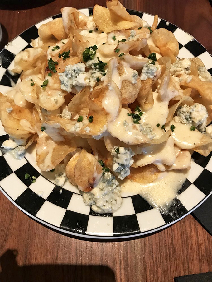 The legendary Blue Cheese Chips—a mountain of crispy potato perfection drowning in tangy cheese sauce. Worth every mile of the journey.