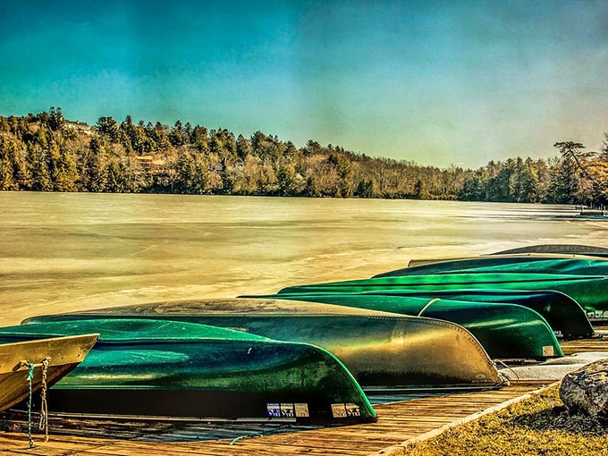 Winter transforms Eagles Mere Lake into a serene landscape of ice and solitude, with upturned canoes patiently awaiting summer's return like hibernating creatures.
