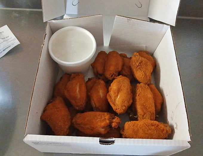 Golden-brown perfection in a humble white box. These wings aren't trying to impress you with fancy sauces—they don't need to.