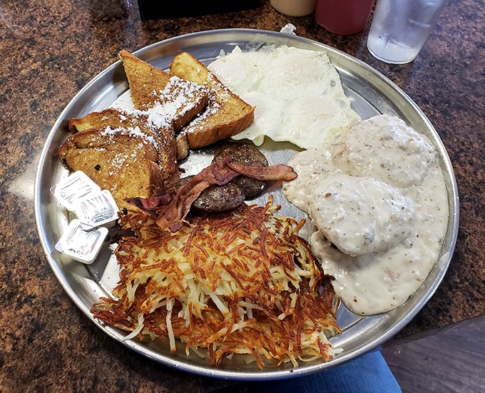 Breakfast nirvana arrives on a metal plate—crispy hash browns, powdered French toast, and gravy that would make your grandmother both jealous and proud.