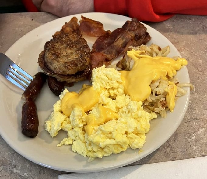 Breakfast of champions! Eggs, sausage, and hash browns with cheese—the holy trinity of morning indulgence that makes getting out of bed worthwhile.