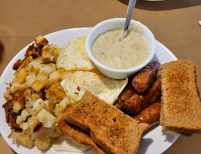 Breakfast perfection on a plate: eggs, home fries, sausage, and gravy. This isn't just a meal; it's morning therapy.