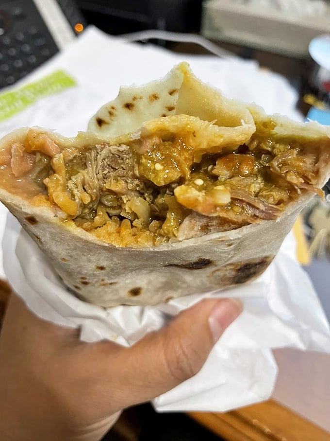 Behold the breakfast burrito in its natural glory—where seasoned meat, fluffy eggs, and potatoes achieve perfect harmony wrapped in a warm tortilla blanket.