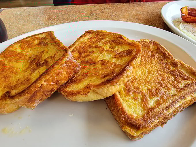 Golden-brown French toast with that perfect caramelized edge that makes you wonder if breakfast might actually be the superior meal of the day.
