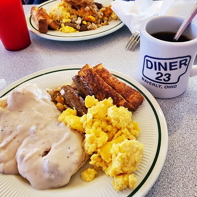 Breakfast perfection doesn't need fancy names. Golden scrambled eggs, sausage links, and toast with a coffee mug that means business. 