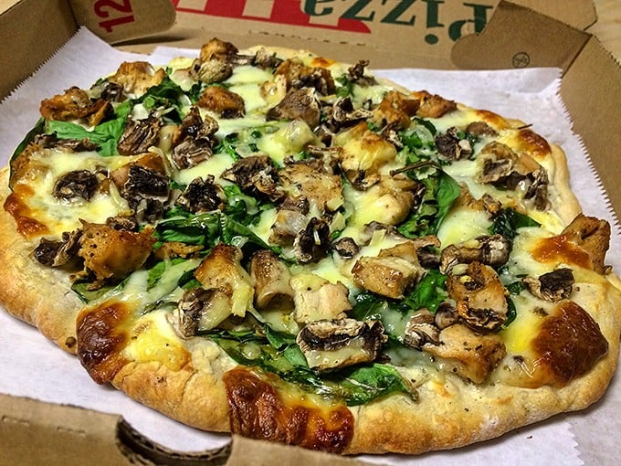 Pizza perfection achieved! This mushroom and spinach masterpiece sports a crust with that magical brick-oven char—crispy exterior, chewy interior—that pizza dreams are made of.