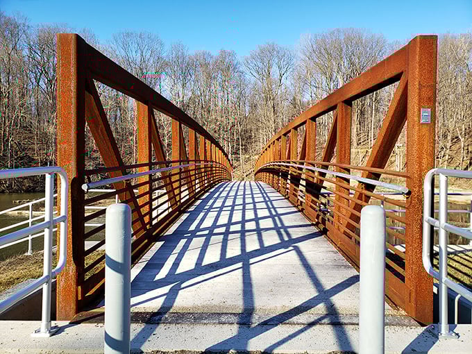 The rust-colored bridge isn't just functional – it's a portal between everyday worries and the simple joy of being surrounded by nature.