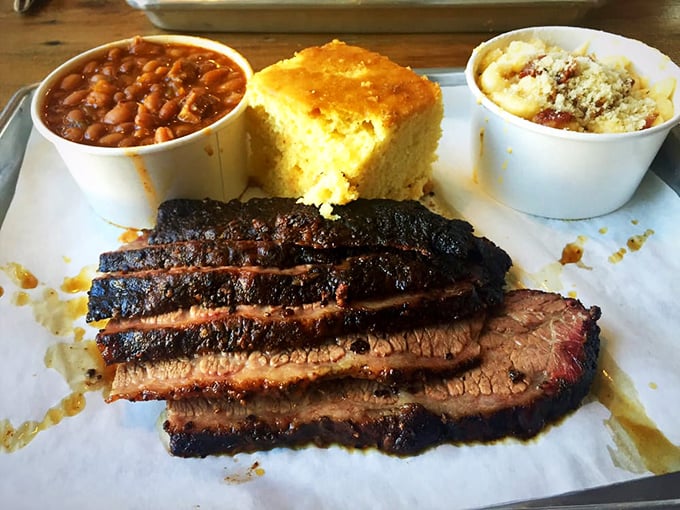 Behold the brisket that launched a thousand road trips—that perfect smoke ring is nature's way of saying "you're welcome."