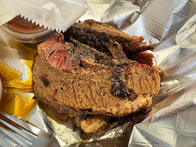 Brisket with a bark so perfect it should be in a museum. That pink smoke ring isn't just pretty—it's a diploma from Barbecue University.
