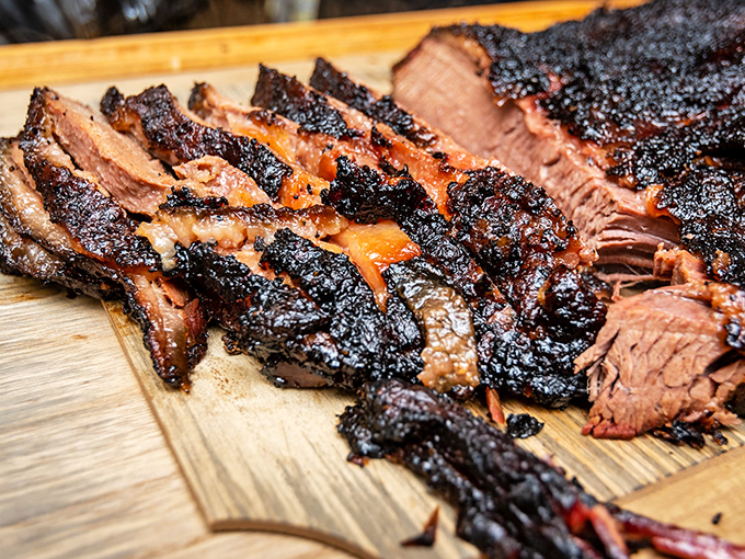 Behold the money shot – brisket with a bark so perfect it deserves its own Instagram account. That smoke ring isn't just pink, it's practically blushing with pride.