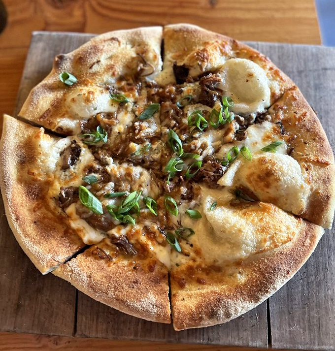 This isn't just pizza—it's a wood-fired masterpiece with melty cheese islands and caramelized crust continents. Geography you can actually eat.