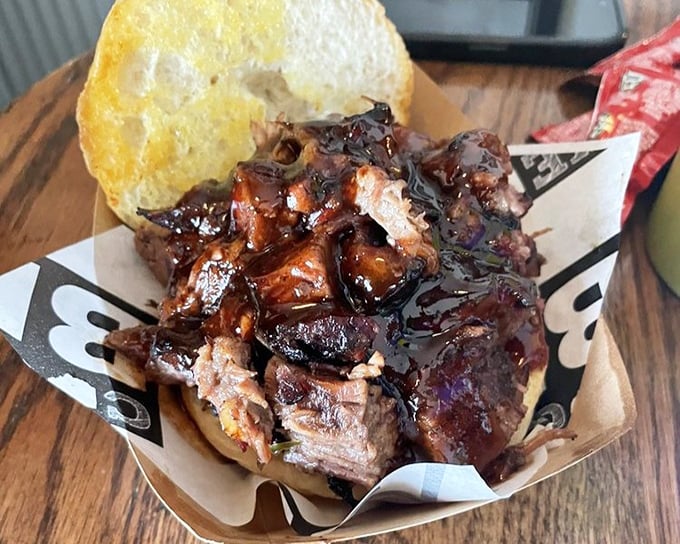 Behold: meat architecture at its finest. This brisket sandwich doesn't just satisfy hunger—it creates memories. The bread is merely a delivery system for smoky perfection.