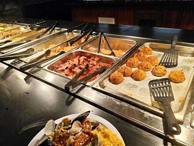 Golden hush puppies stand at attention next to savory offerings—the buffet equivalent of a receiving line for your taste buds.