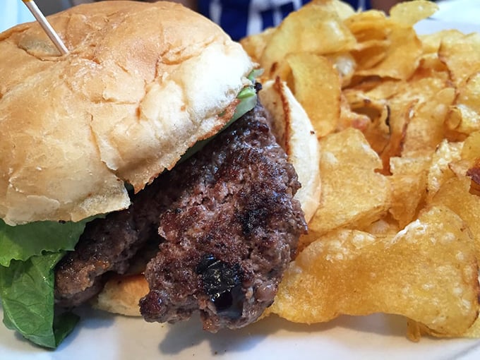 Behold the burger that makes grown adults weep tears of joy – perfectly grilled with golden chips alongside.