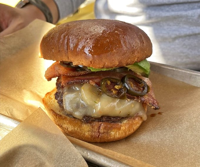 This isn't just a burger—it's a masterclass in umami, with melted cheese cascading over a perfect patty, topped with jalapeños and bacon.