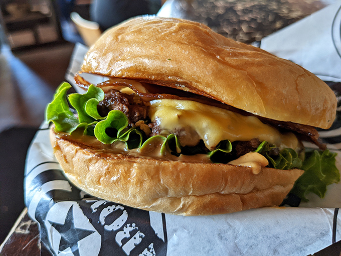 Behold, the burger of your dreams—where melty cheese cascades over a perfectly seared patty while crisp lettuce stands by, pretending to make it healthy.