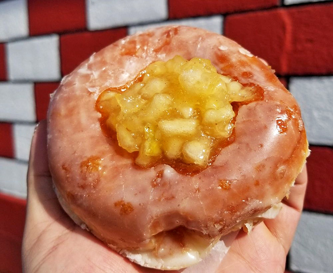 This apple-filled donut isn't just breakfast—it's edible therapy. The pink glaze and caramelized apple center create a sweet harmony that Mozart would have appreciated.