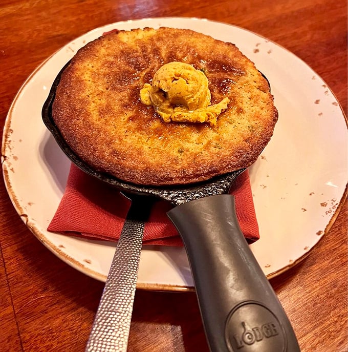 Golden, crusty perfection in cast iron – this cornbread isn't just a side dish, it's practically the main event with that melting honey-chipotle butter.