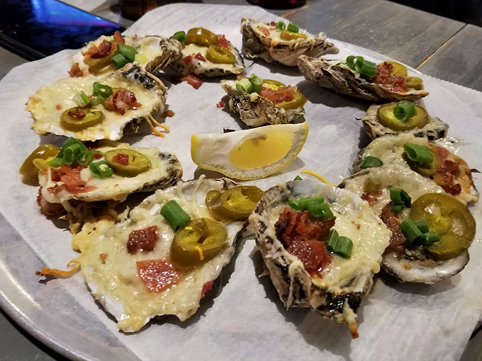 These chargrilled oysters aren't just cooked, they're transformed. Melted cheese, bacon bits, jalapeños – it's what happens when the ocean meets comfort food.