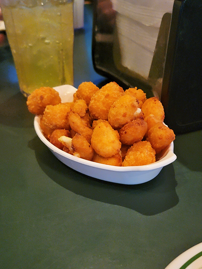 Golden nuggets of joy! These cheese curds achieve the perfect balance of crispy exterior and molten interior—Wisconsin's contribution to world happiness.