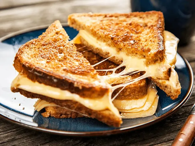 Behold, the grilled cheese of your dreams—where the cheese pull requires a building permit. Comfort food engineering at its finest.