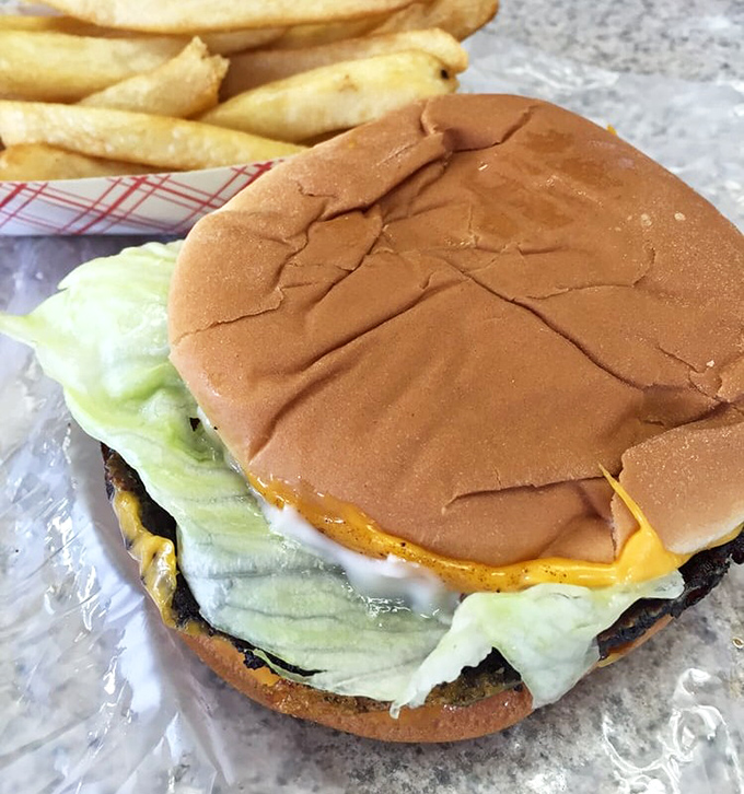 Behold, the cheeseburger of your dreams – where melty American cheese meets fresh lettuce in a dance as old as time itself.
