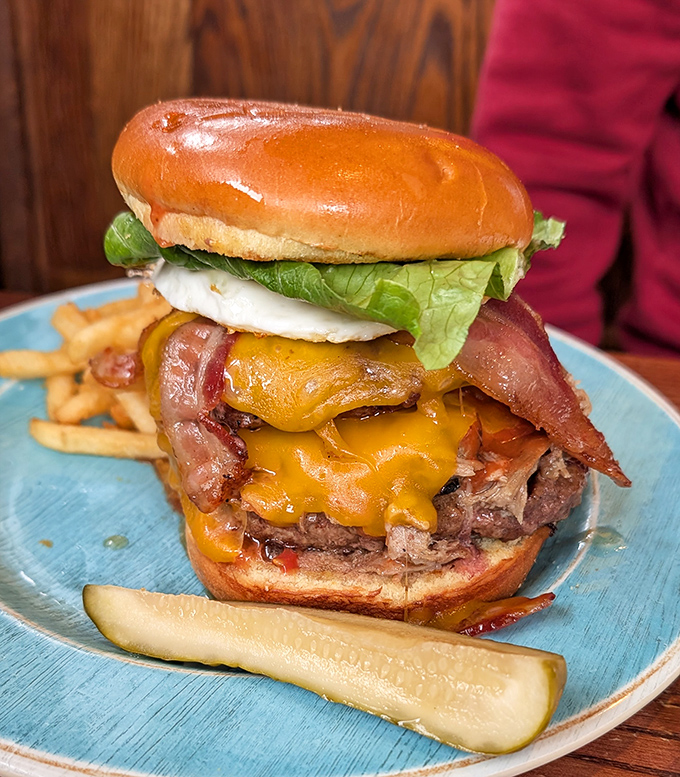 Behold, burger perfection! Melted cheese cascading over a juicy patty with bacon standing at attention—this is edible architecture at its finest.