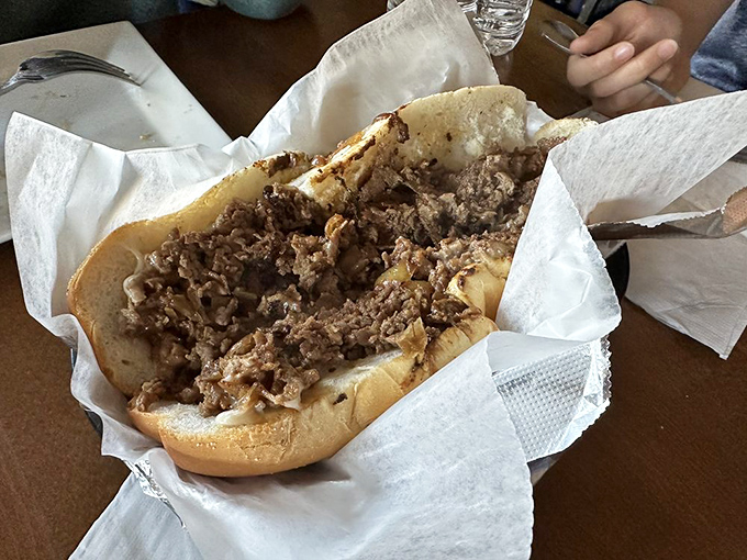 This isn't just a cheesesteak—it's a masterclass in simplicity. Thinly sliced ribeye nestled in a perfect roll, no passport to Philly required.