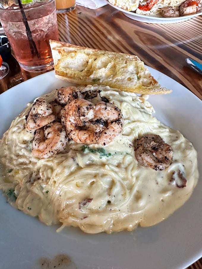 Creamy pasta heaven topped with perfectly seasoned shrimp. This plate makes you understand why some people propose to their food.