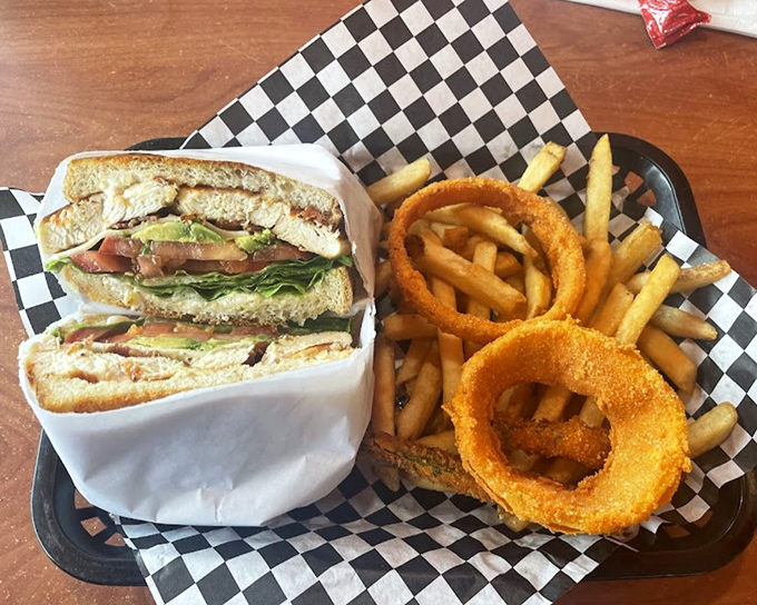 This chicken club sandwich arrives like a perfectly orchestrated symphony of flavors and textures.