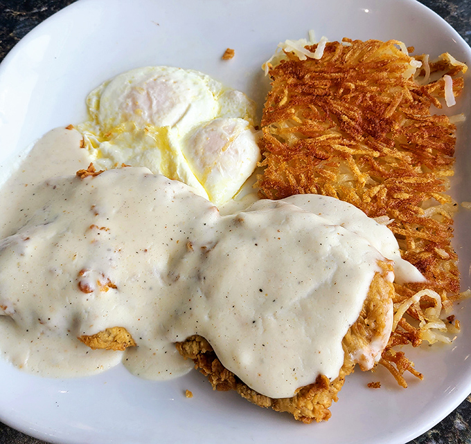 Chicken fried steak nirvana – golden, crispy coating swimming in peppery cream gravy that would make your grandmother weep with joy.