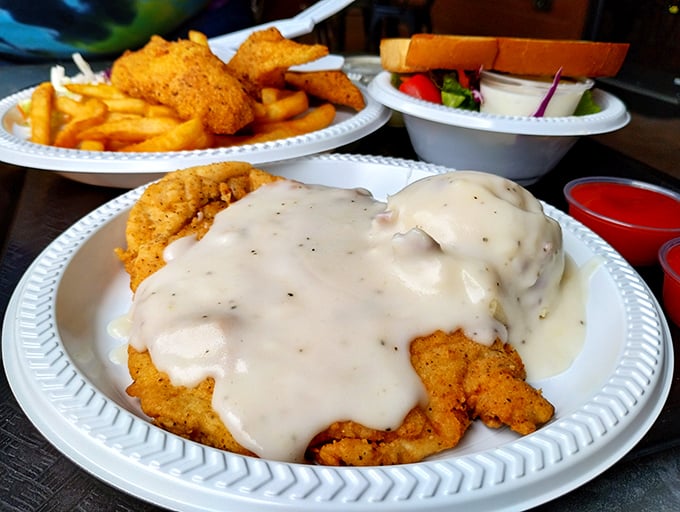 Behold the star of the show: golden-crusted chicken fried steak swimming in peppery cream gravy, flanked by crispy fries and a token salad for "balance."