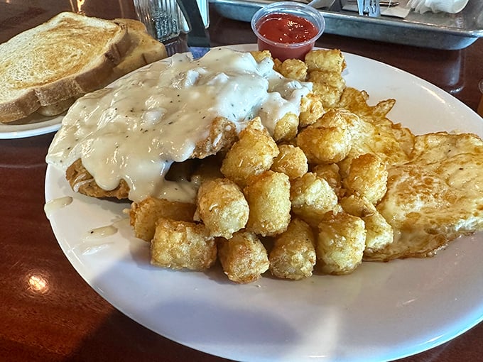 Behold the holy grail of comfort food! This chicken fried steak with its golden armor of crispy batter comes draped in gravy that could make a vegetarian weep.