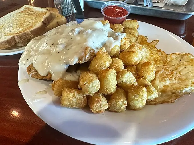 Behold the holy grail of comfort food! This chicken fried steak with its golden armor of crispy batter comes draped in gravy that could make a vegetarian weep.