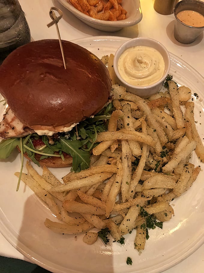 Not all heroes wear capes – some come on brioche buns. This chicken sandwich with its perfectly golden exterior and mountain of crispy fries demands respect and napkins.