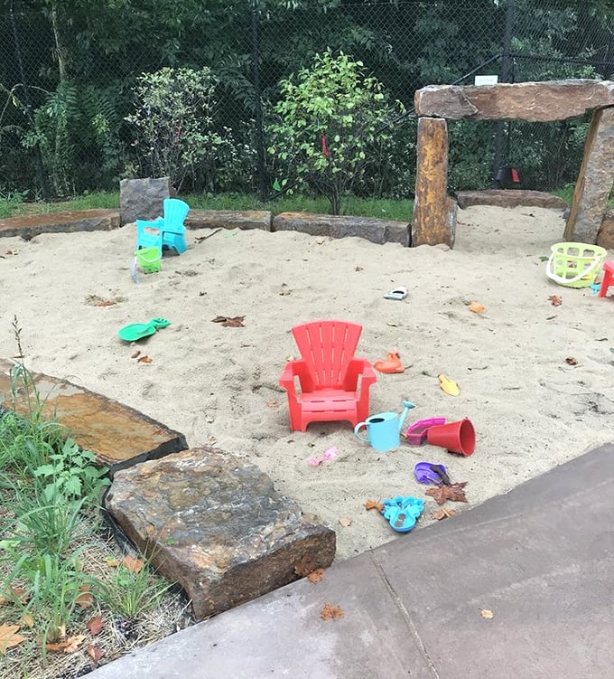 The children's sandbox area proves that kids and plants share one crucial trait—they both thrive when given room to play.