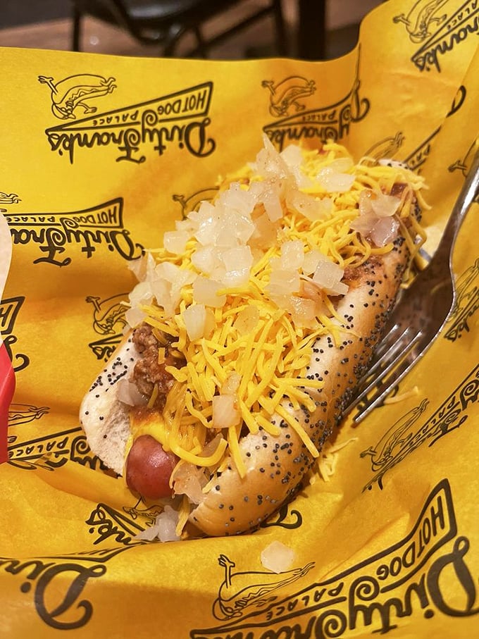 Not your standard ballpark frank! This cheese-smothered, onion-topped creation proves that sometimes the best things in life come nestled in a poppy seed bun.