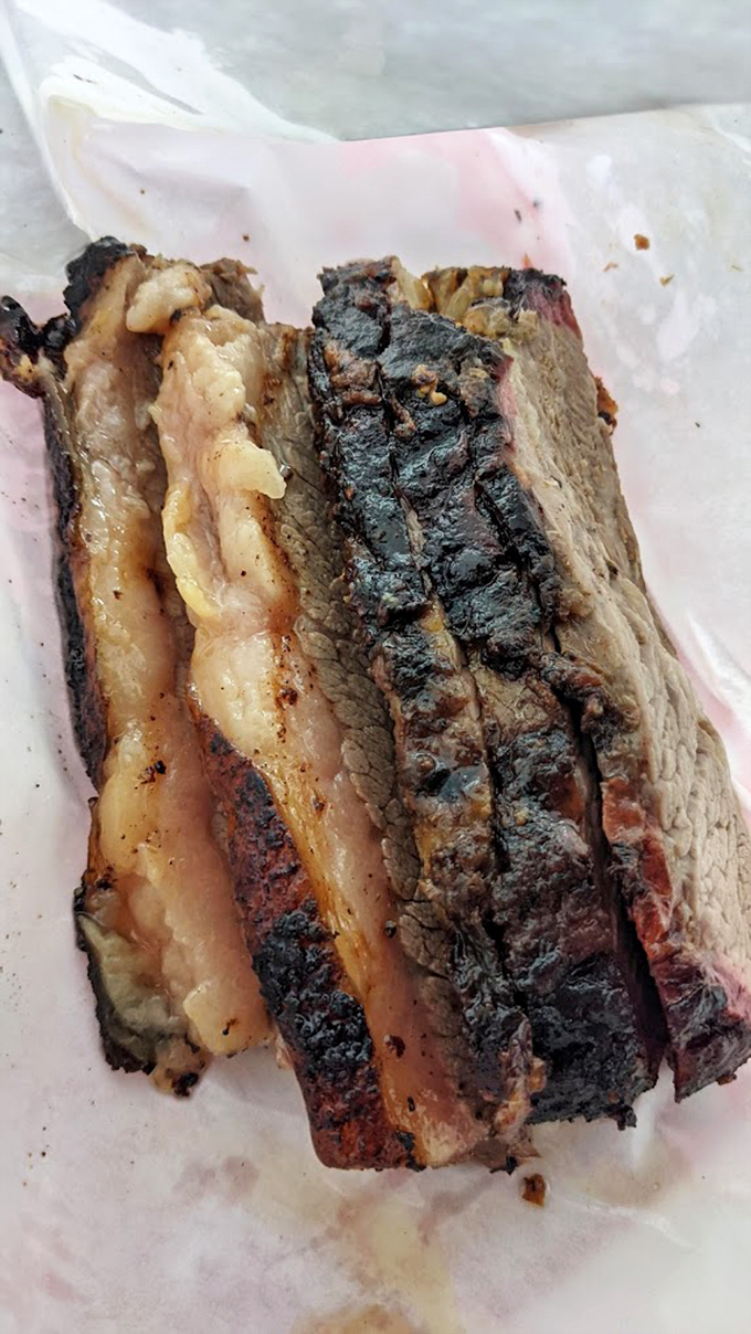 Behold the holy trinity of barbecue perfection: bark, smoke ring, and tender meat. This brisket doesn't need Instagram filters—it's already wearing nature's most beautiful colors.