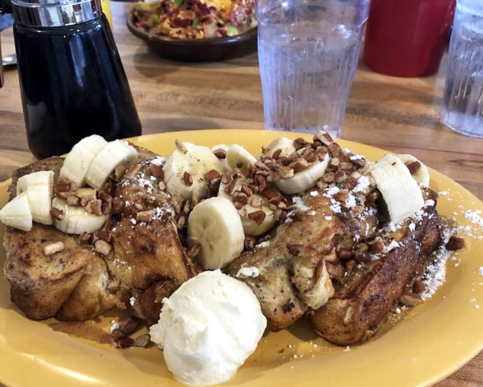 French toast that's had a spa treatment—pampered with cinnamon, crowned with bananas, and given a pecan confetti shower.