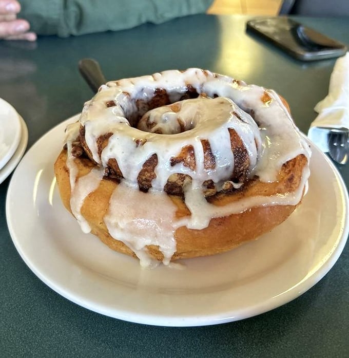 Behold the crown jewel: a cinnamon roll that's practically architectural. Layers of dough spiral beneath an avalanche of glaze that knows no boundaries.