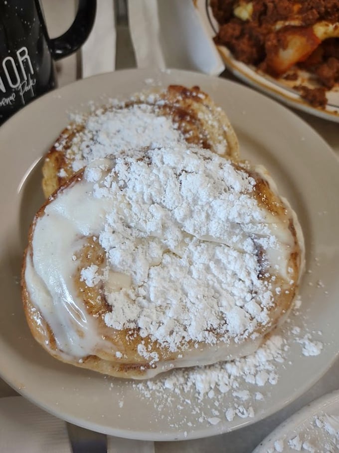 Not all heroes wear capes—some wear powdered sugar. These cinnamon rolls arrive looking like they just won a confectionary beauty pageant.