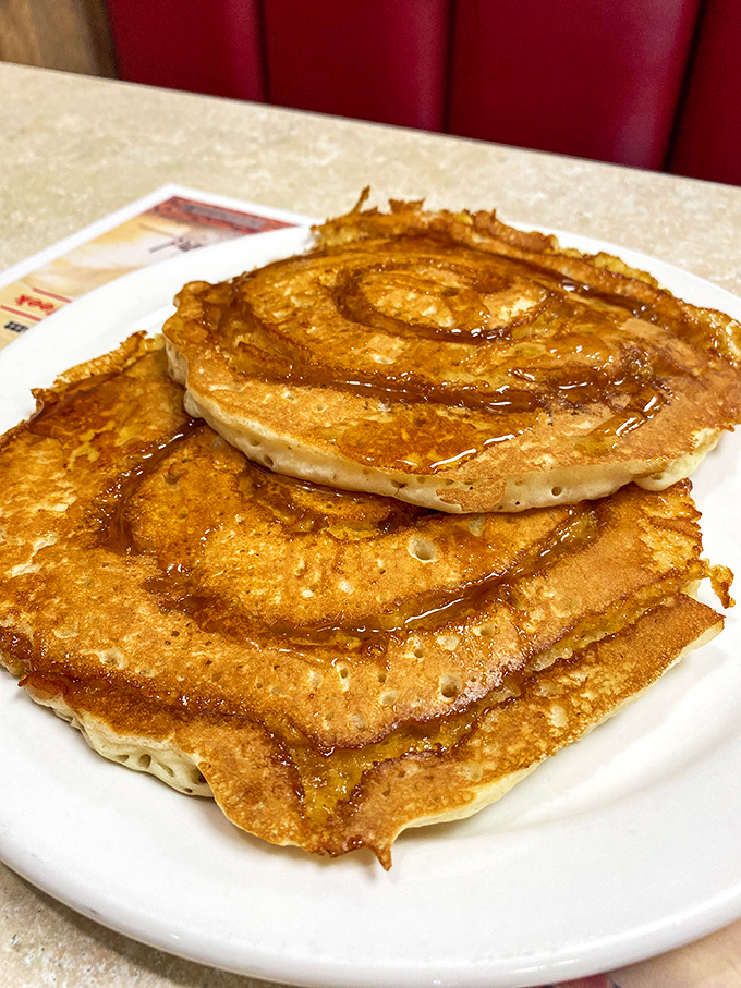 Cinnamon swirl pancakes that make you question every other breakfast decision you've ever made—golden, spiraled perfection waiting for maple's embrace.