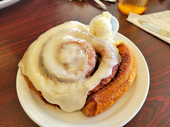 This isn't just a cinnamon roll – it's a spiritual experience with a butter pat crown. The frosting doesn't drip, it cascades with purpose.