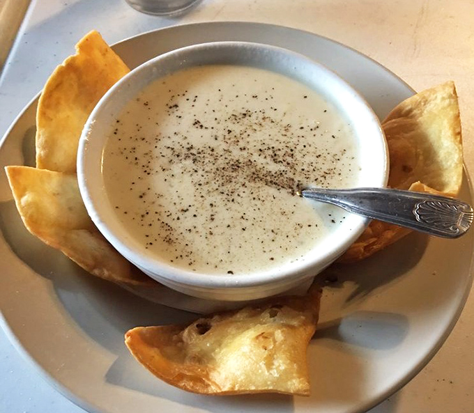 Creamy clam chowder that demands to be savored slowly. Those crispy tortilla chips aren't just garnish—they're essential dipping instruments for maximum enjoyment.
